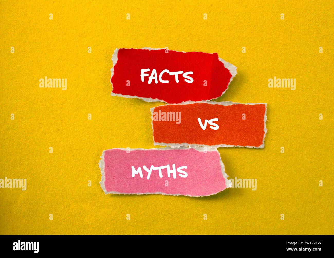 Facts vs myths words written on torn paper pieces with yellow ...