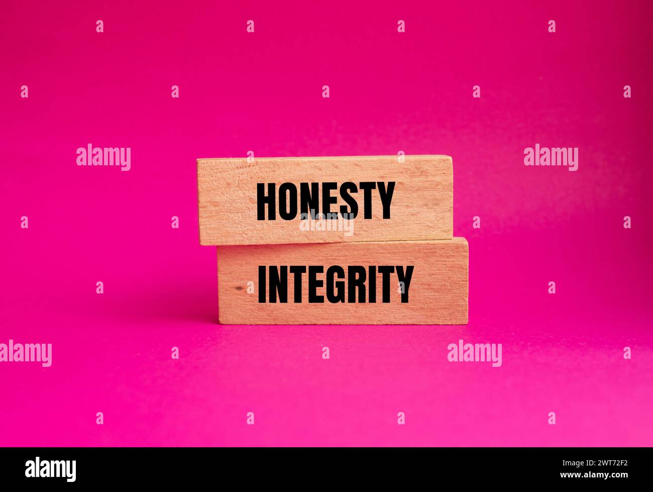 Honesty and integrity words written on wooden blocks with pink ...