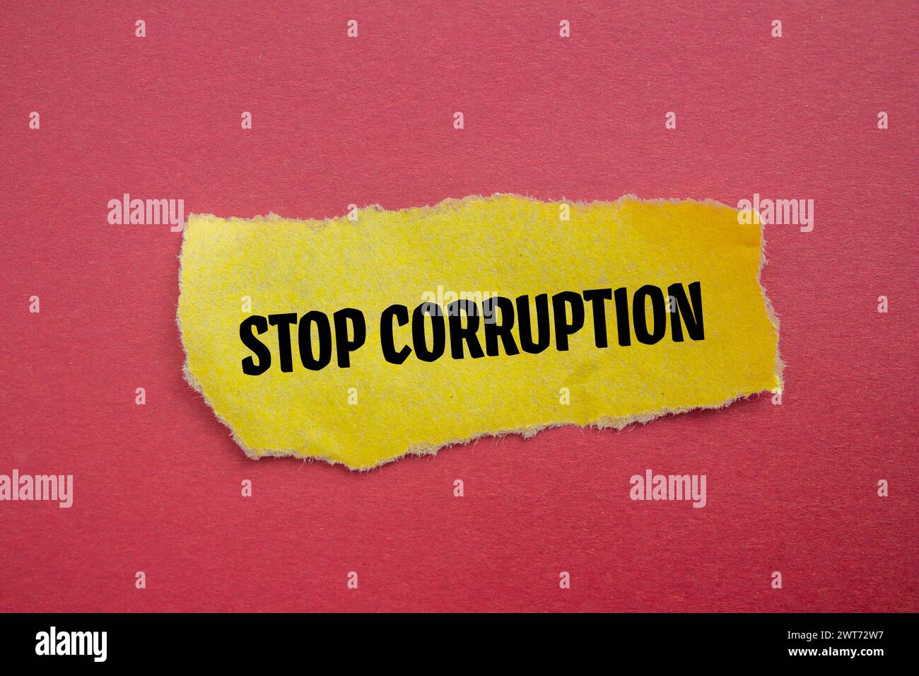 Stop corruption words written on yellow torn paper with red background ...