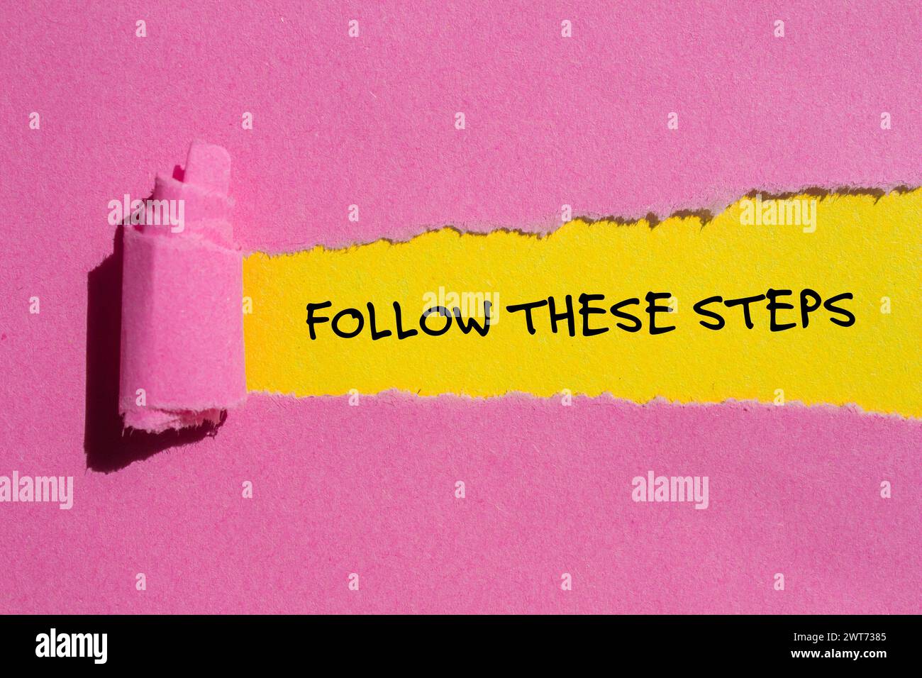 Follow these steps words written on torn pink paper with yellow ...