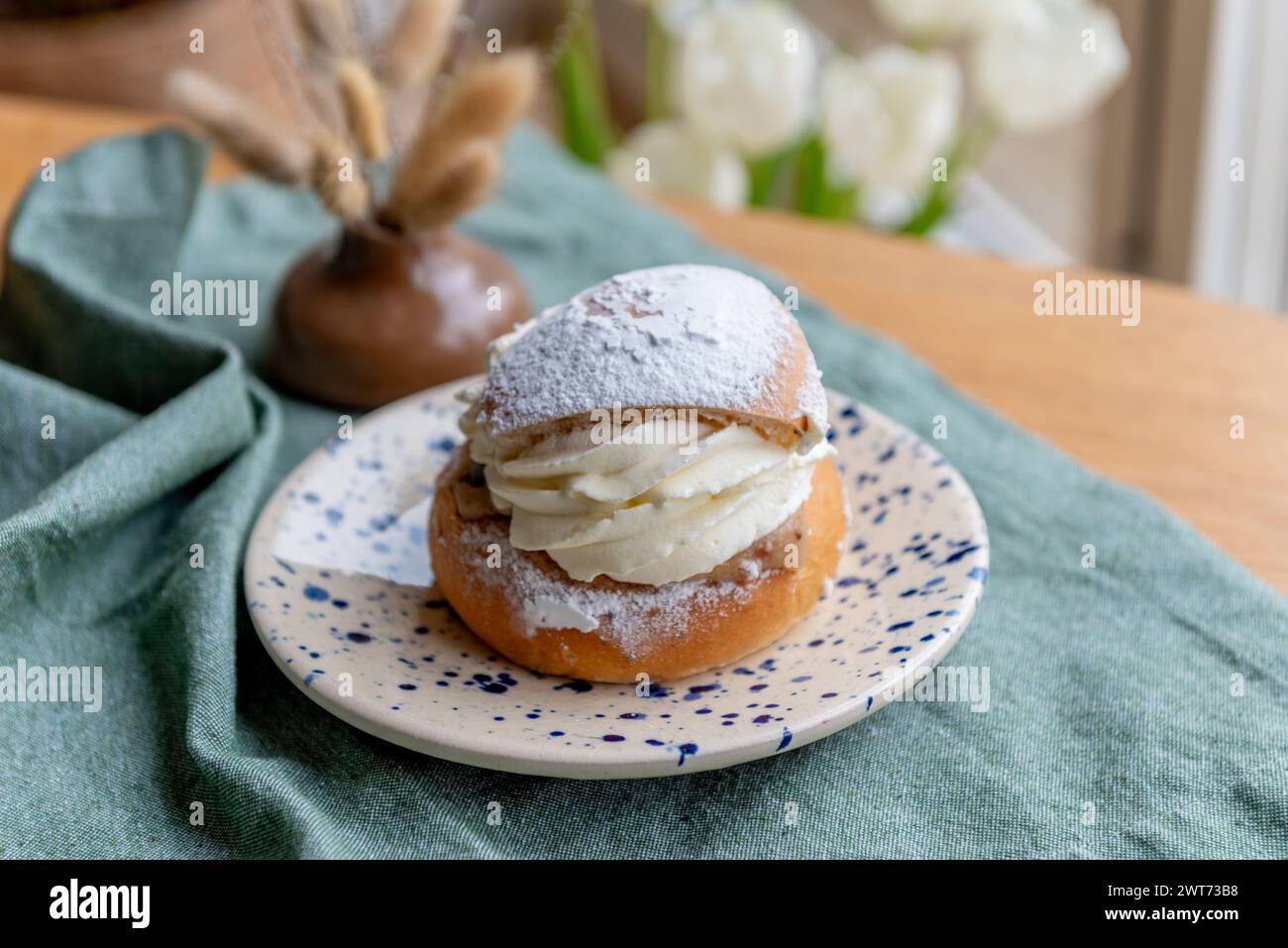 Typical Swedish semla with sweet cream on te blue textile Stock Photo ...