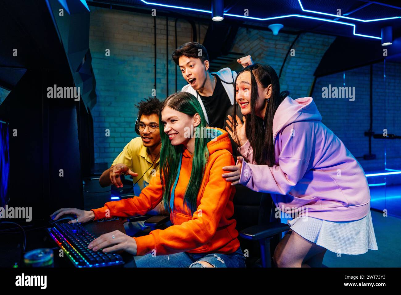 Multiethnic group of young friends playing videogames - Team of ...