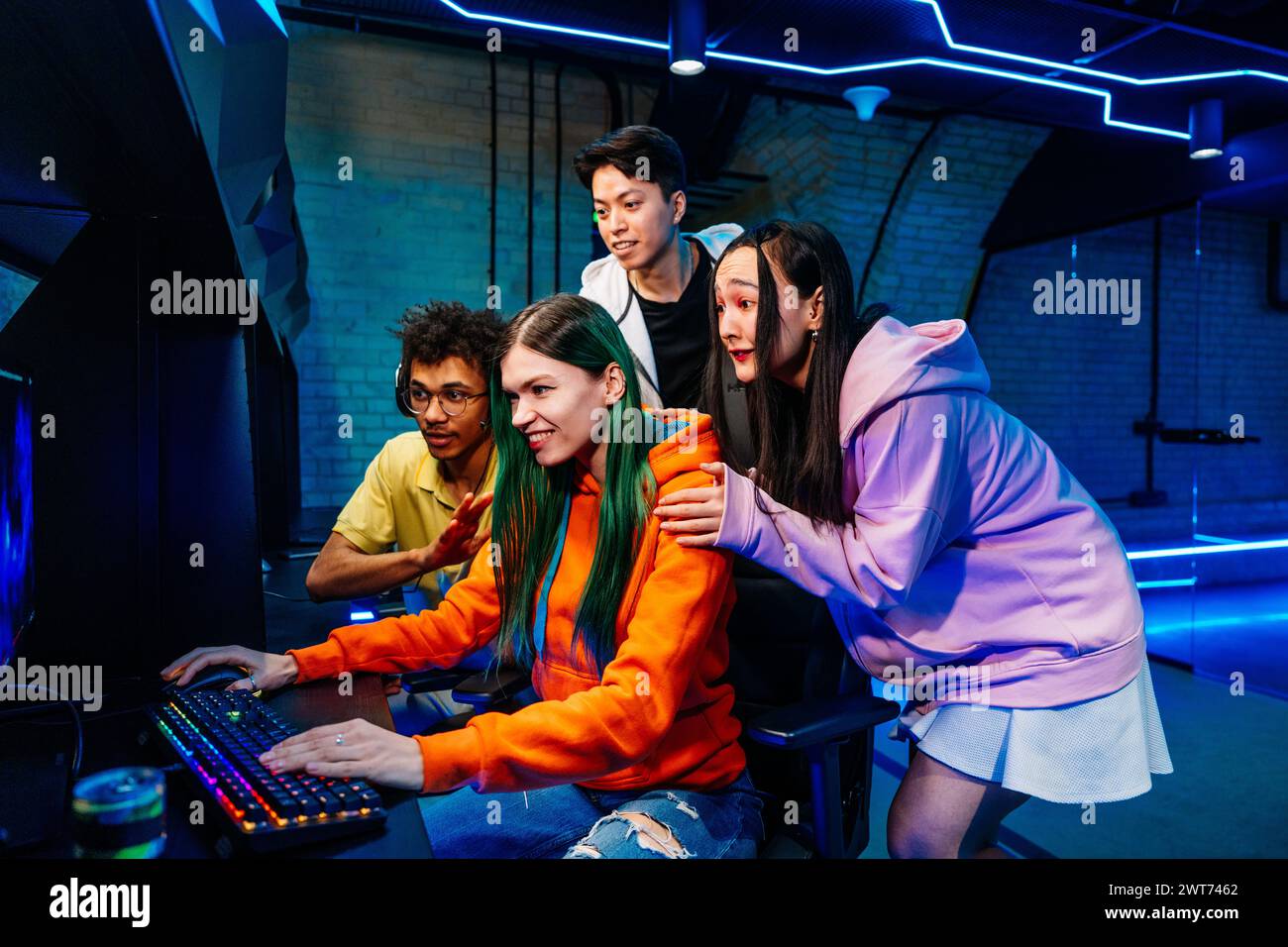 Multiethnic group of young friends playing videogames - Team of ...