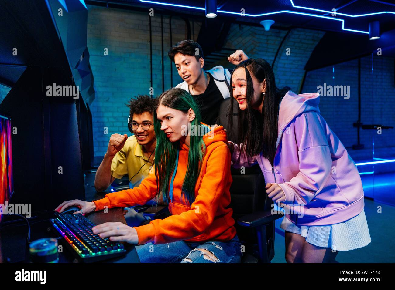 Multiethnic group of young friends playing videogames - Team of ...