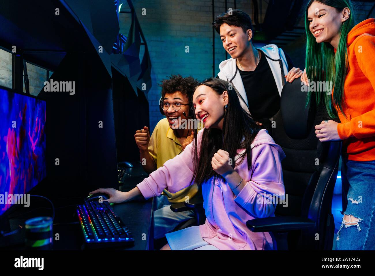 Multiethnic group of young friends playing videogames - Team of ...