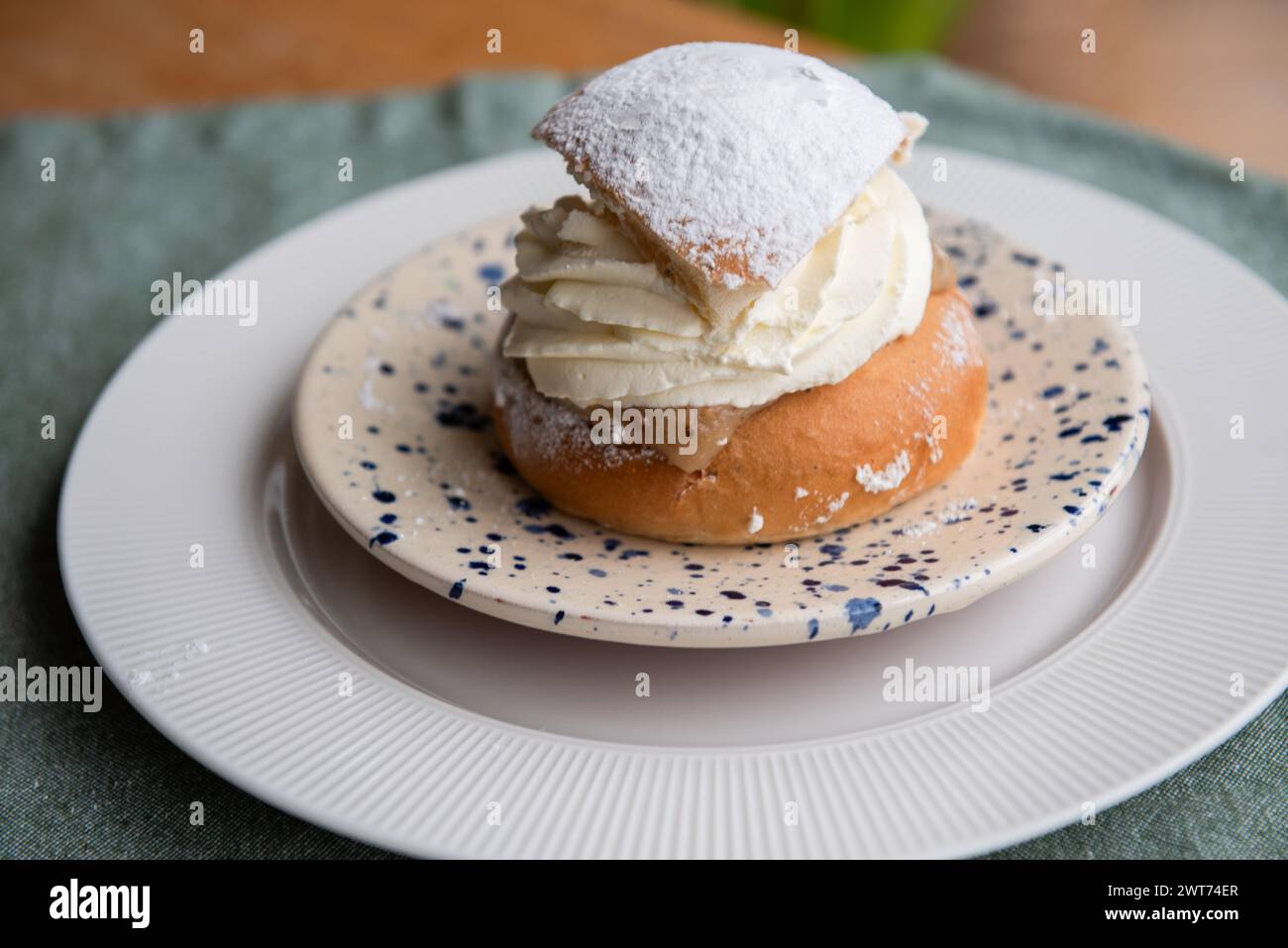 Typical Swedish semla with sweet cream on te blue textile Stock Photo ...