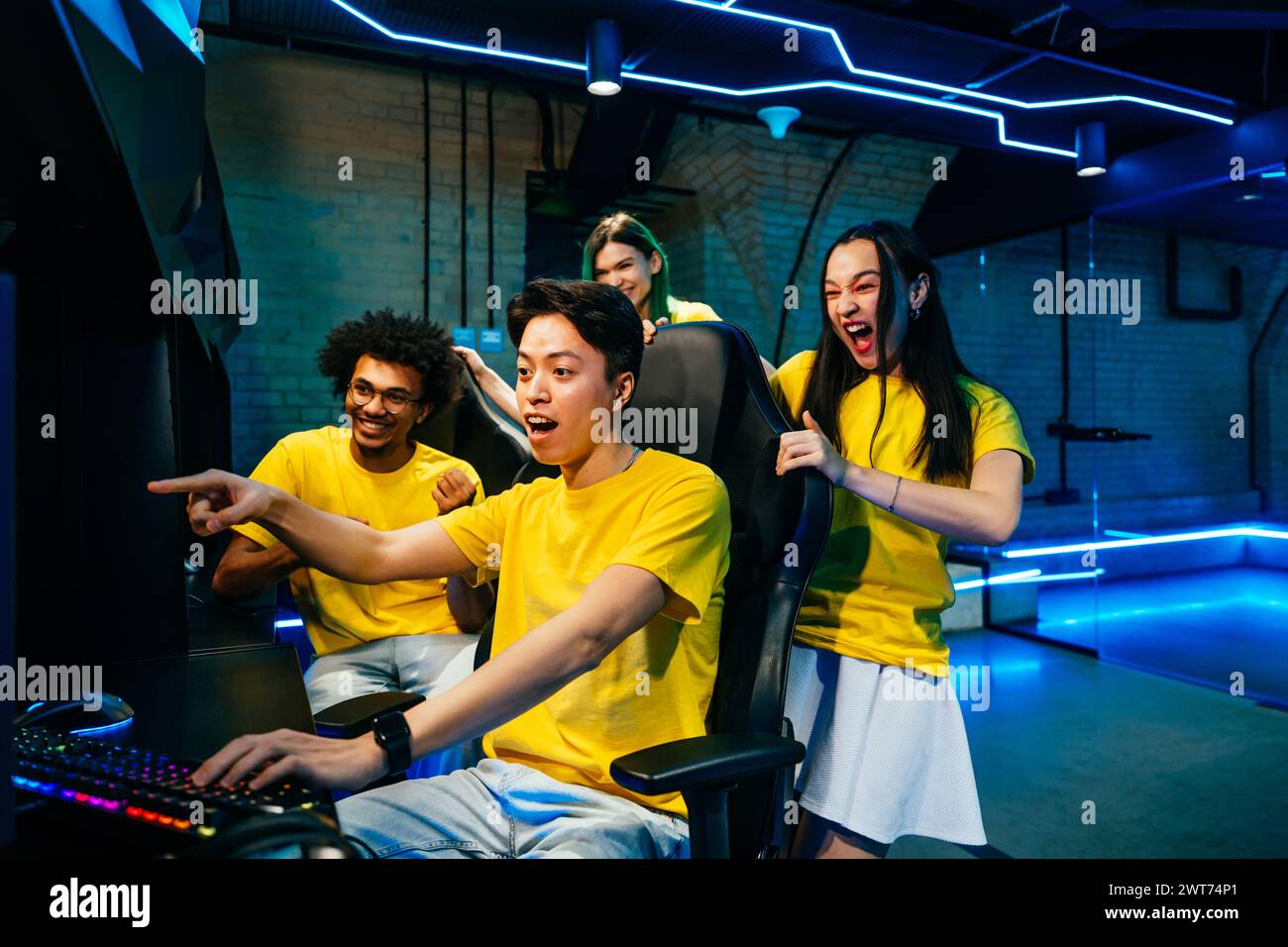 Multiethnic group of young friends playing videogames - Team of ...