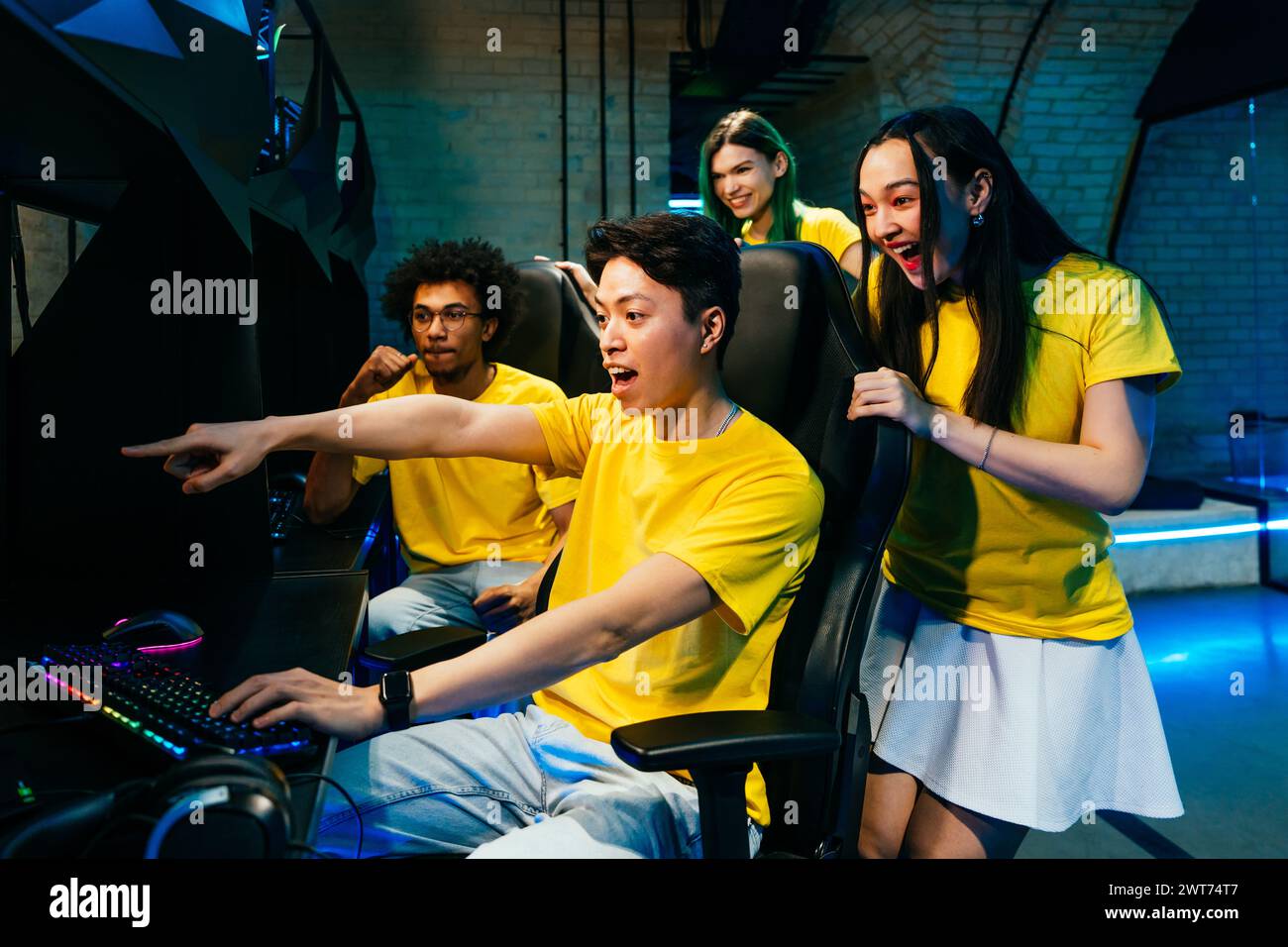 Multiethnic group of young friends playing videogames - Team of ...