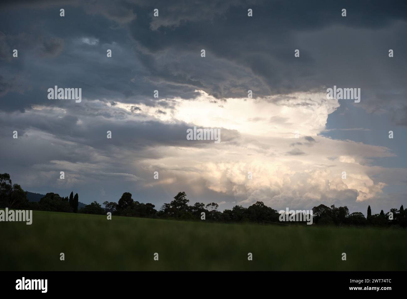 Wide image of large storm clouds in distance Stock Photo - Alamy