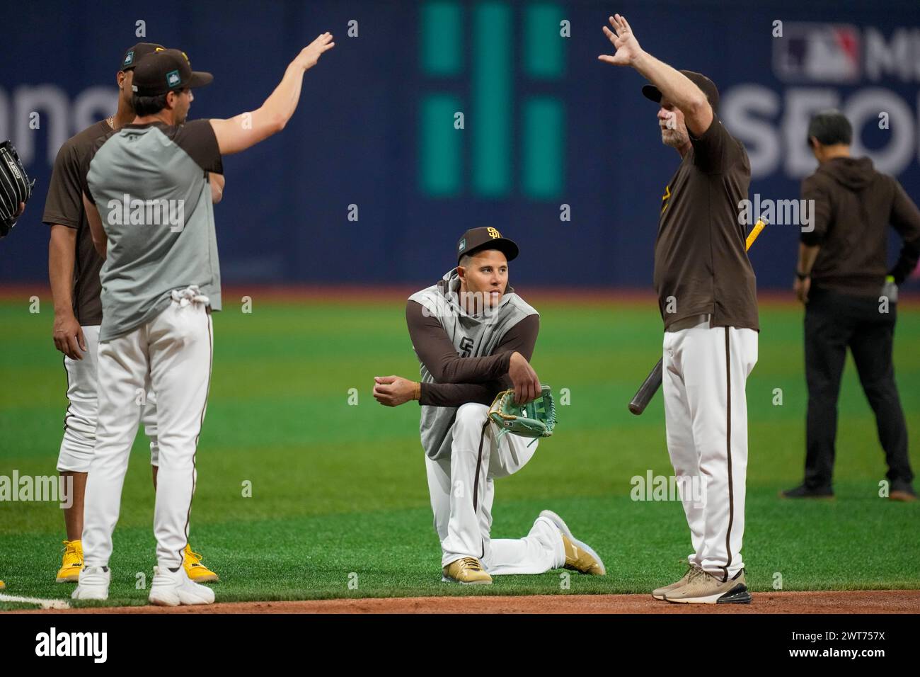 San Diego Padres third baseman Manny Machado, center, kneels before the ...