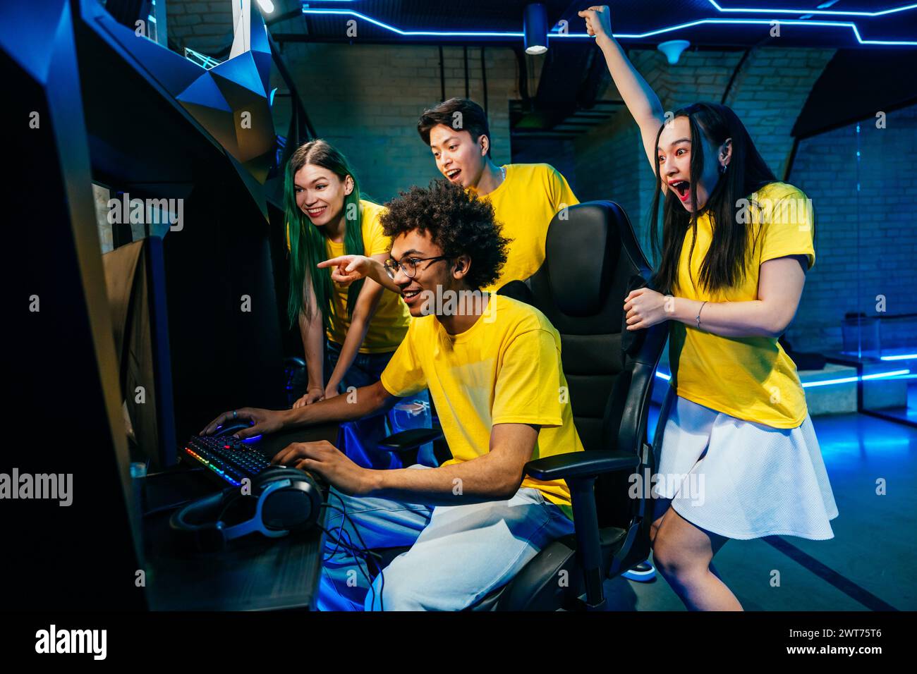 Multiethnic group of young friends playing videogames - Team of ...