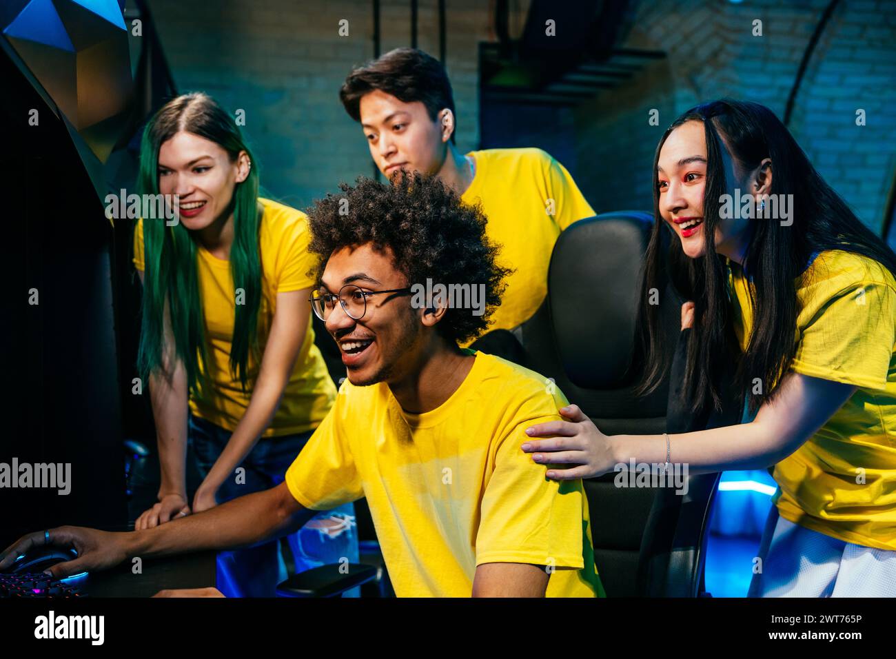 Multiethnic group of young friends playing videogames - Team of ...