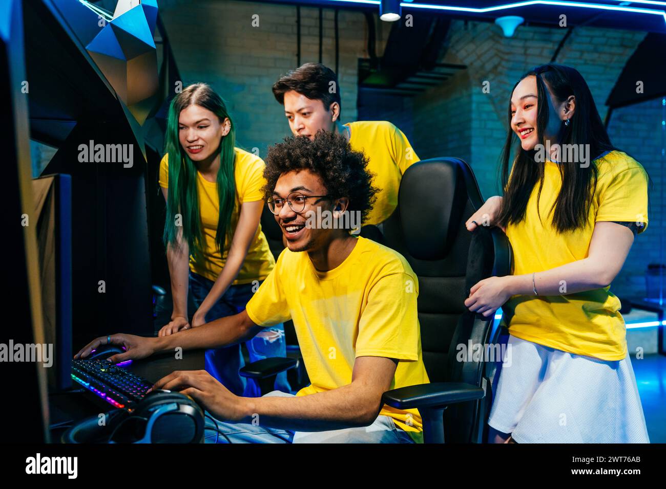 Multiethnic group of young friends playing videogames - Team of ...
