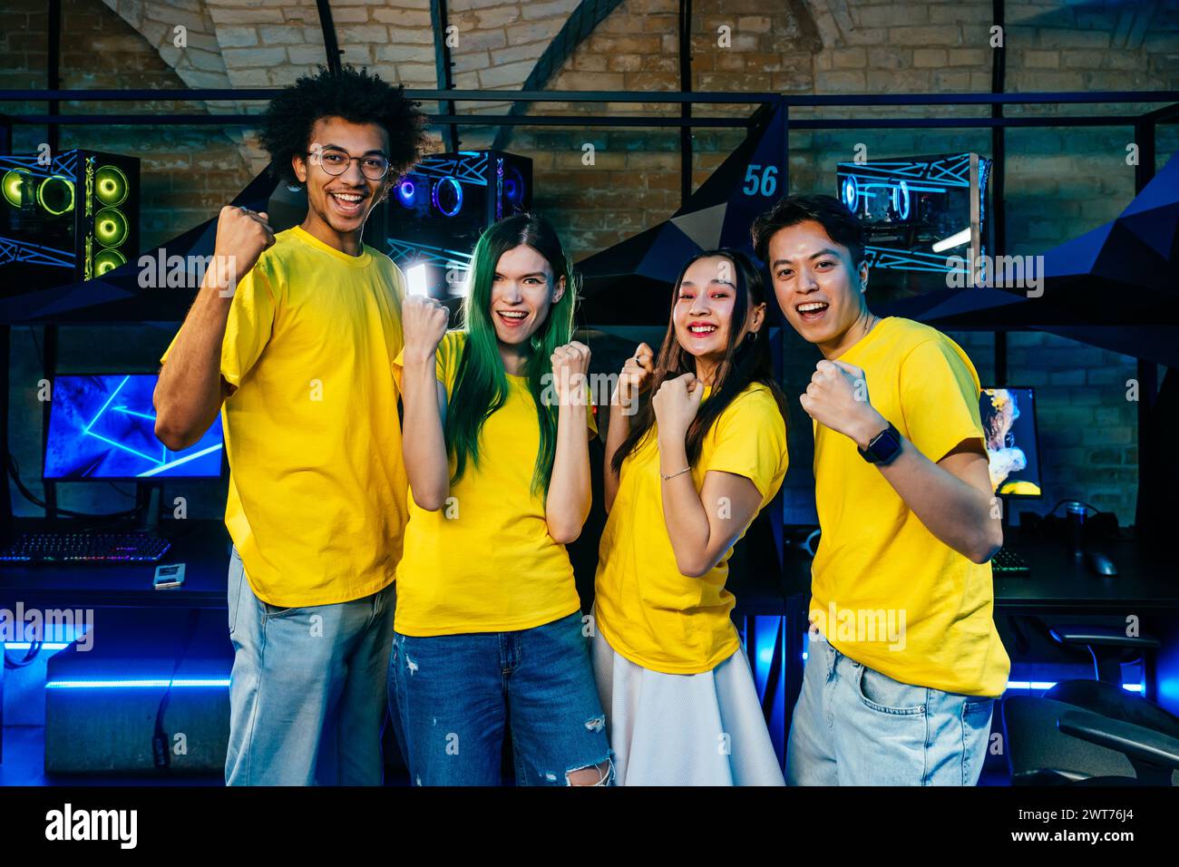 Multiethnic group of young friends playing videogames - Team of ...