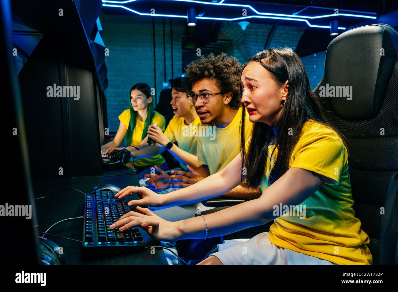 Multiethnic group of young friends playing videogames - Team of ...