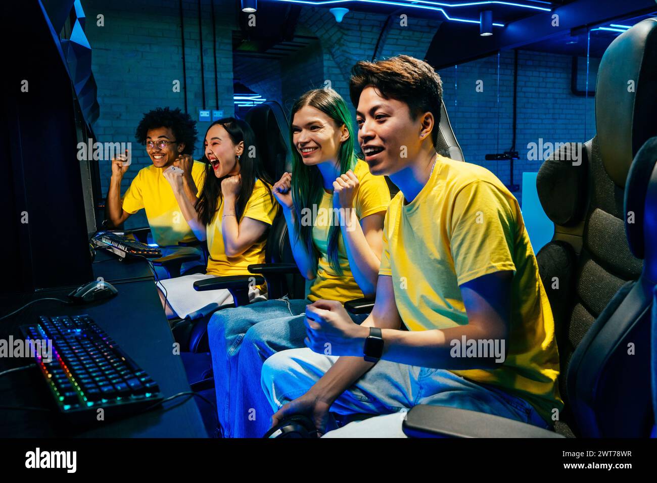 Multiethnic group of young friends playing videogames - Team of ...