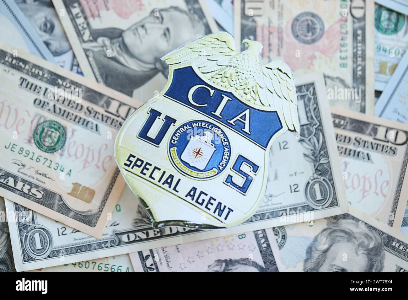 KYIV, UKRAINE - MARCH 9, 2024 US CIA Central Intelligence Agency badge on many US dollar bills ...