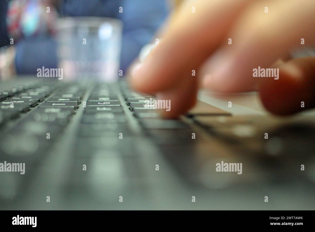 boy is pressing the keys of a laptop to find information for school ...