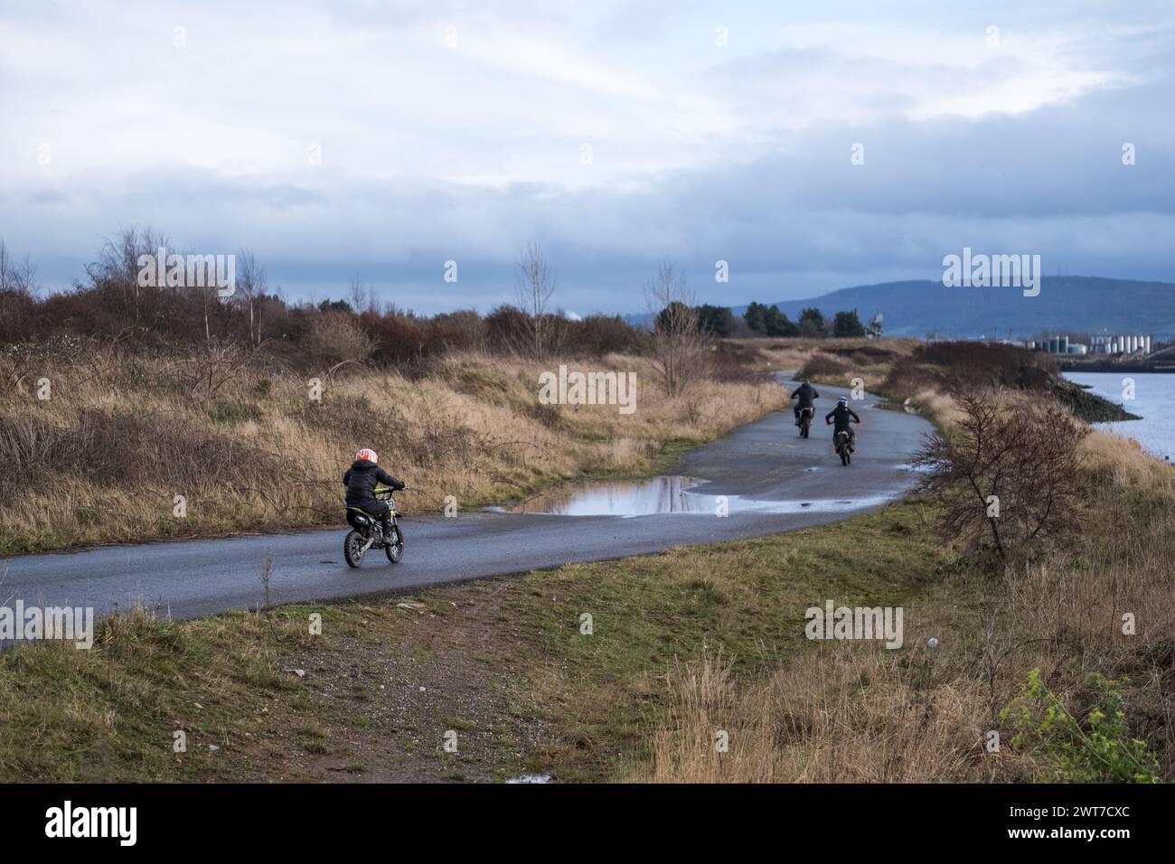 Boys on dirt bikes ride on track beside the river Tees, in Port ...