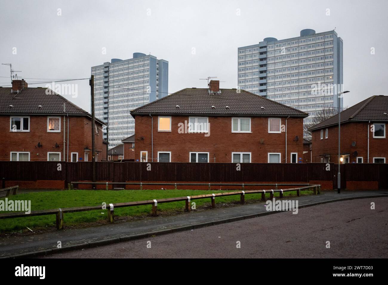 Two high rise tower blocks looming in the background of a housing ...