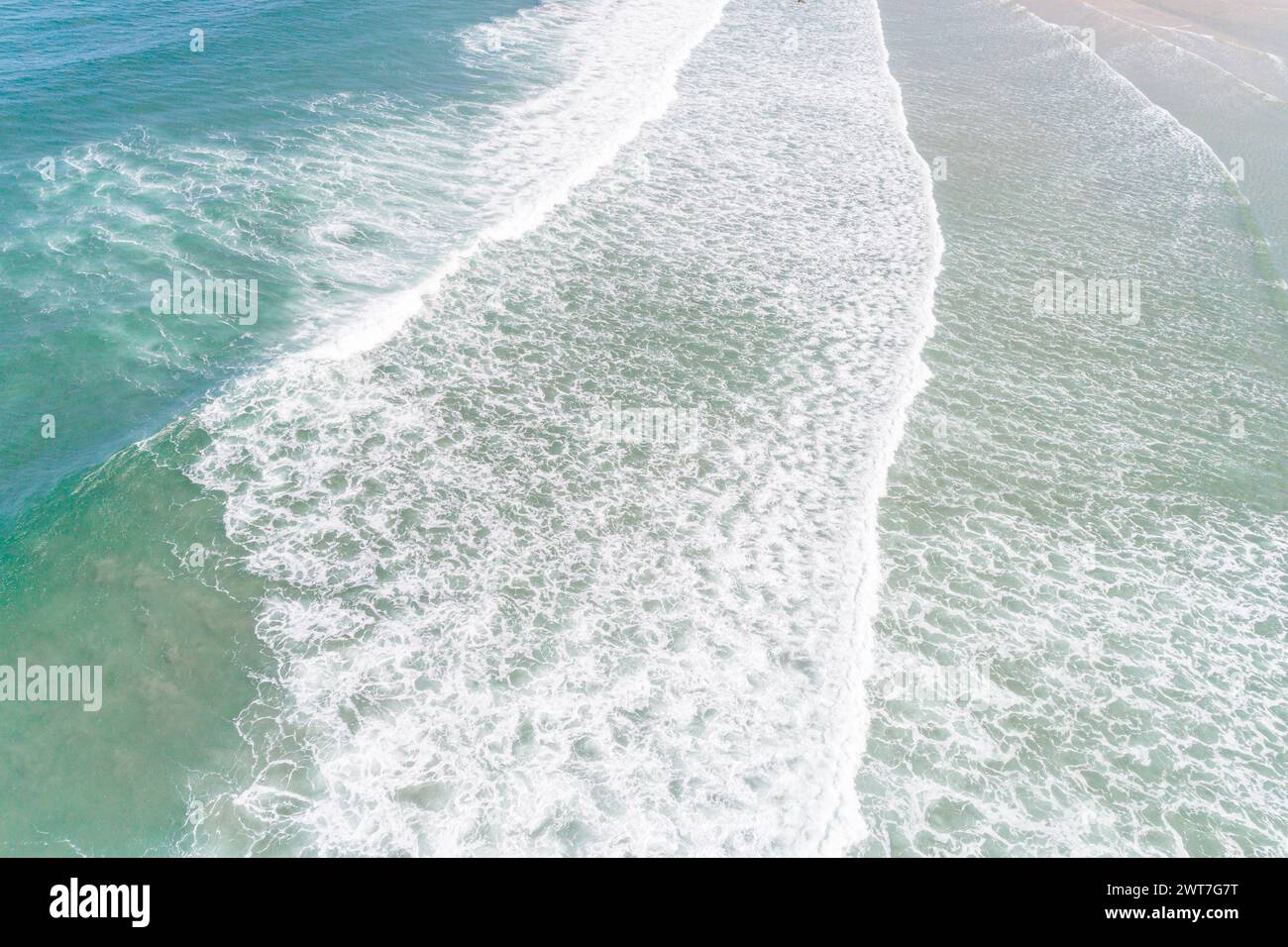 The ocean is calm and the waves are small. The water is a beautiful ...