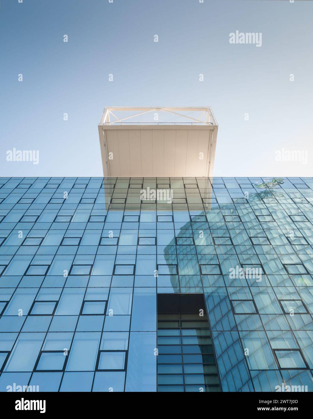 Blue glass facade of modern building with many windows. Clear blue sky ...