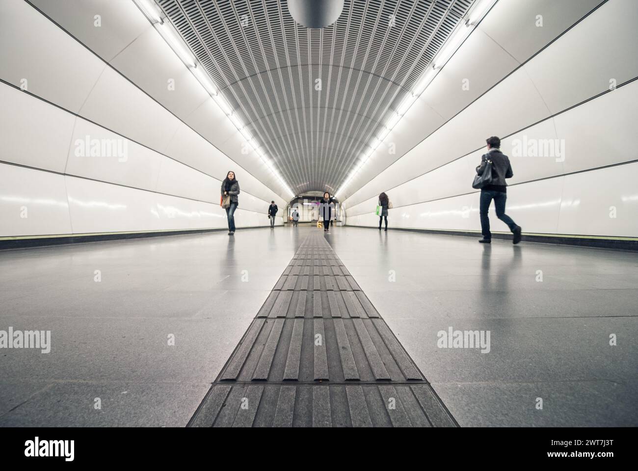 Subway station walkway tunnel - low angle view. Perspective view of ...