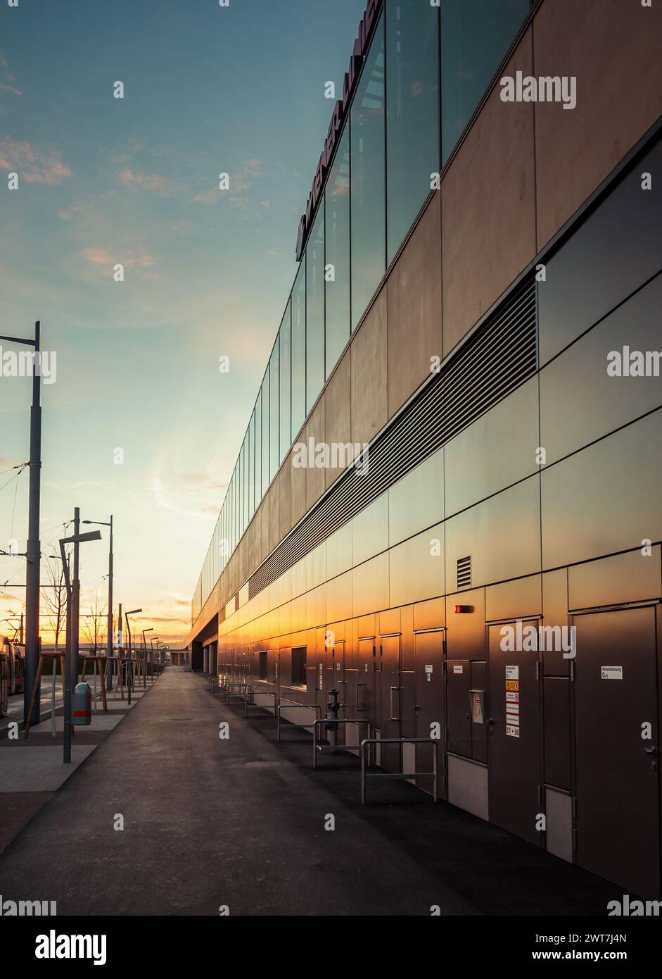 Elevated subway station exterior at sunset. Perspective view of walkway ...