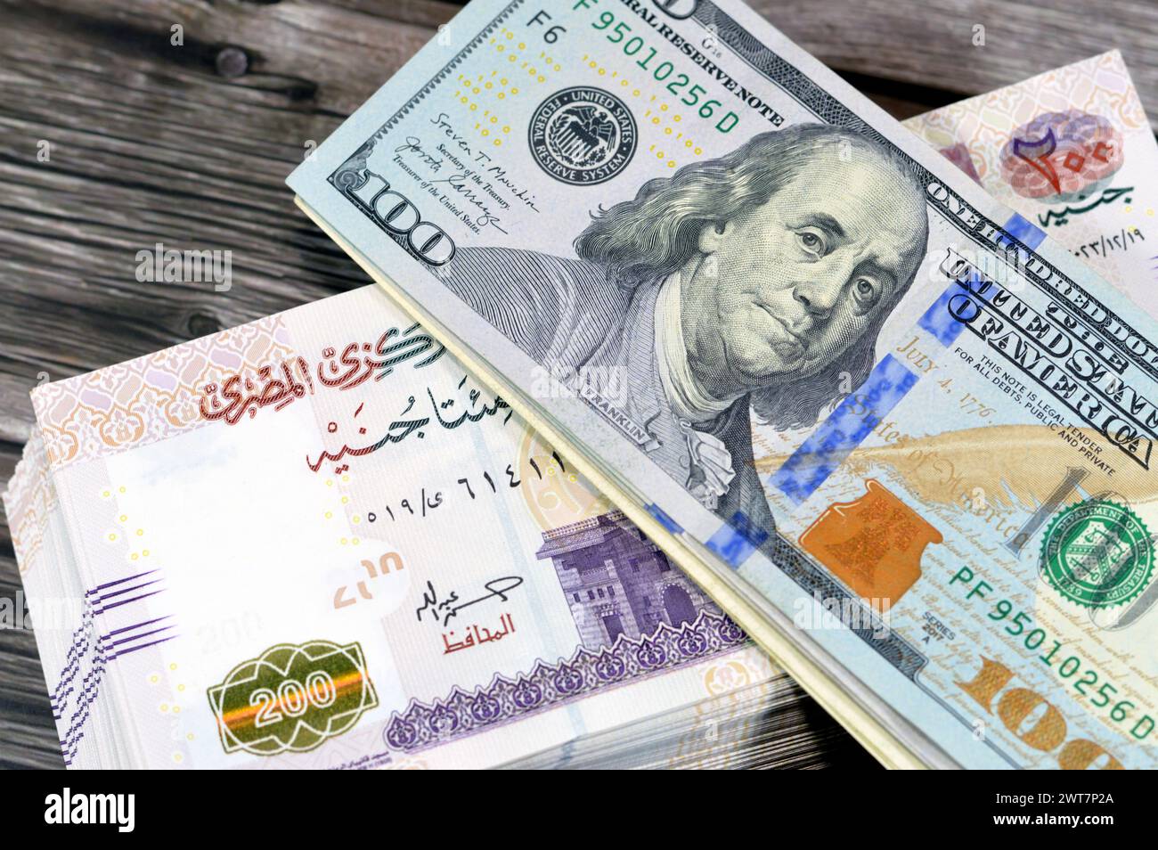 USD American cash of 100 dollars and Egyptian money banknotes of 200 ...