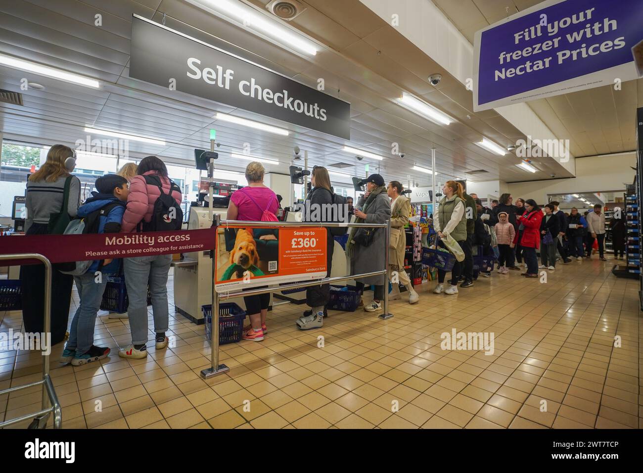 London, UK 16 March 2024 . Long queues of shoppers at the self ...