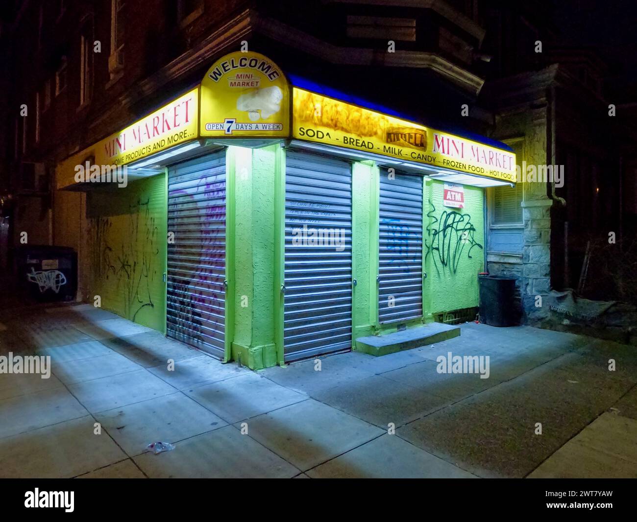 The lights of a corner store shine before morning hours at a corner ...