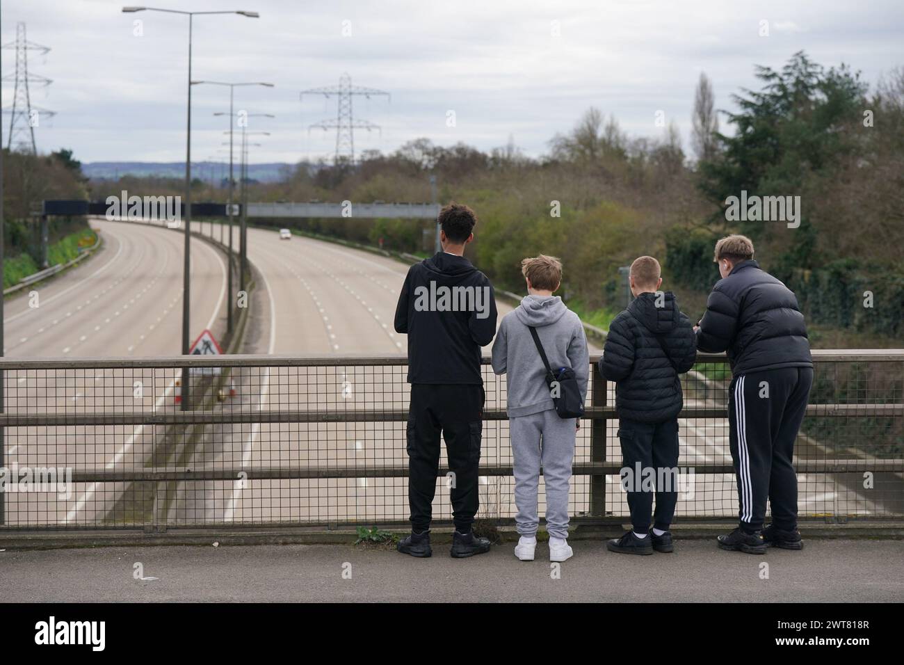 Young boys stand on the Parvis Road bridge in Byfleet, that crosses ...