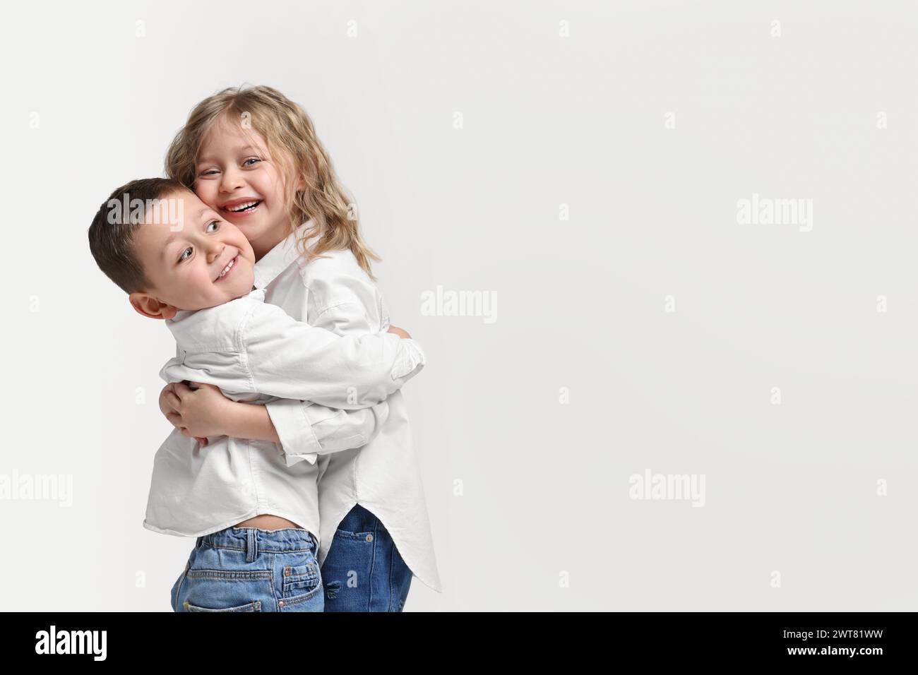 Cute little children hugging on white background. Space for text Stock ...