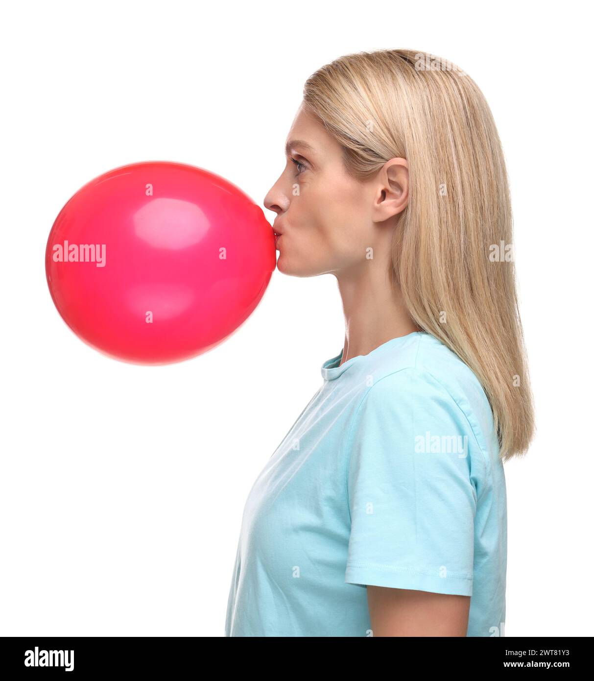 Woman blowing up balloon on white background Stock Photo - Alamy