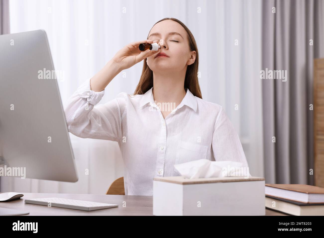 Medical drops. Young woman using nasal spray at home indoors Stock ...