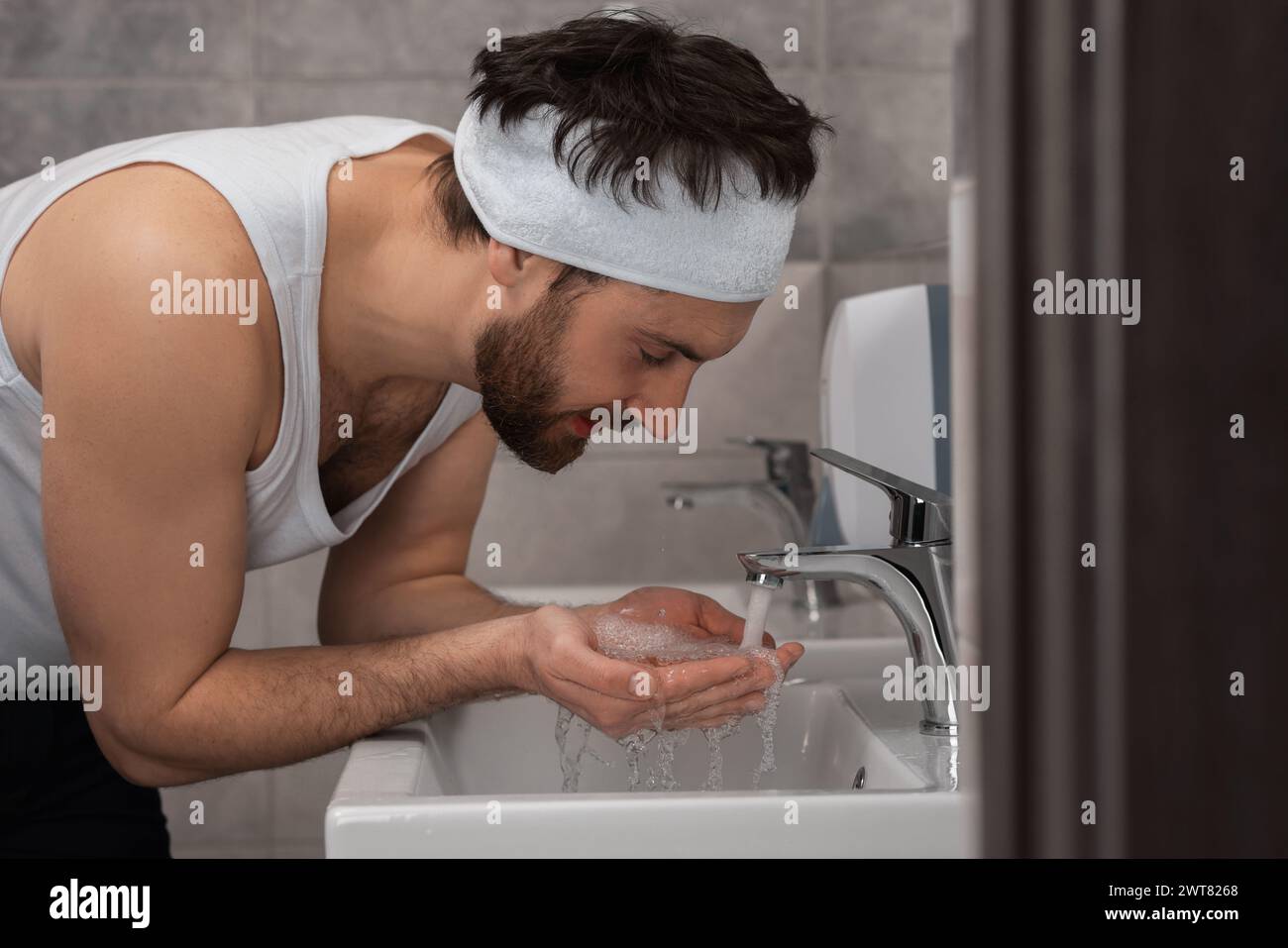 Man washing face in sink hi-res stock photography and images - Alamy