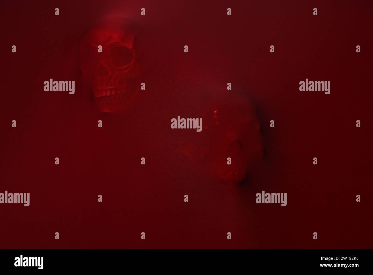 Silhouette of creepy ghost with skulls behind red cloth Stock Photo - Alamy
