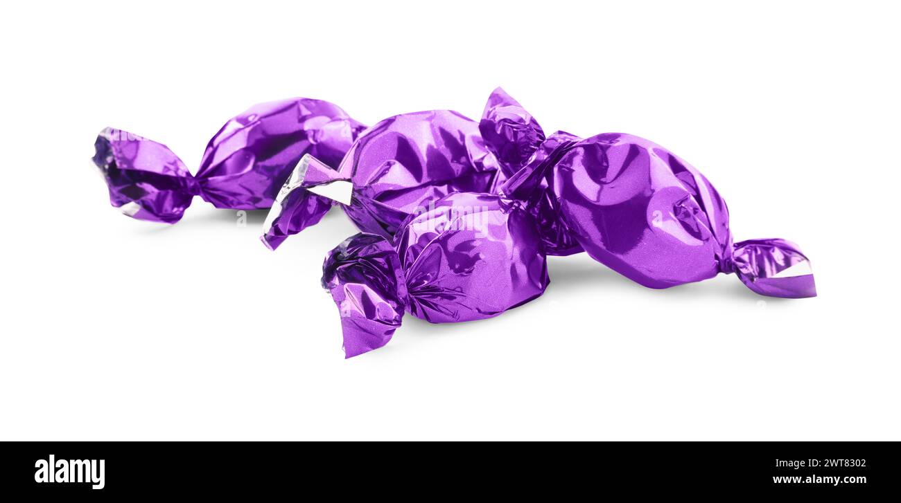 Candies in purple wrappers isolated on white Stock Photo - Alamy