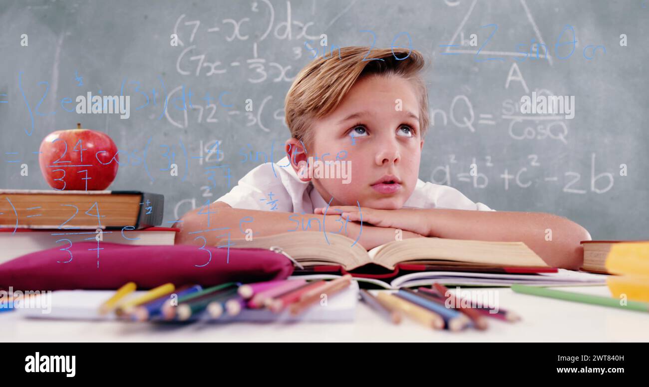 Image of math formulas over thoughtful caucasian boy learning at school ...
