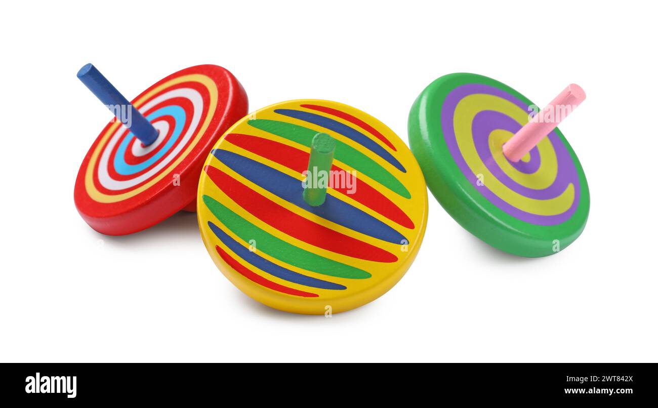 Many bright spinning tops isolated on white Stock Photo - Alamy
