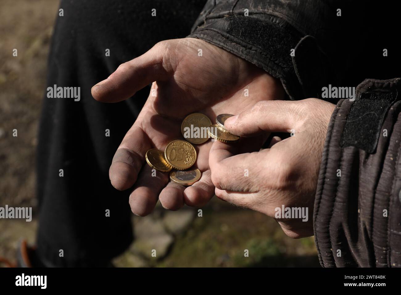 Poor homeless man holding coins outdoors, closeup Stock Photo - Alamy