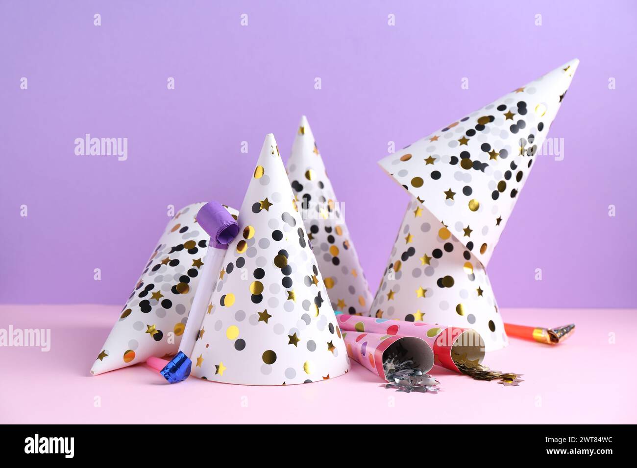 Party hats, confetti and blowers on color background Stock Photo - Alamy