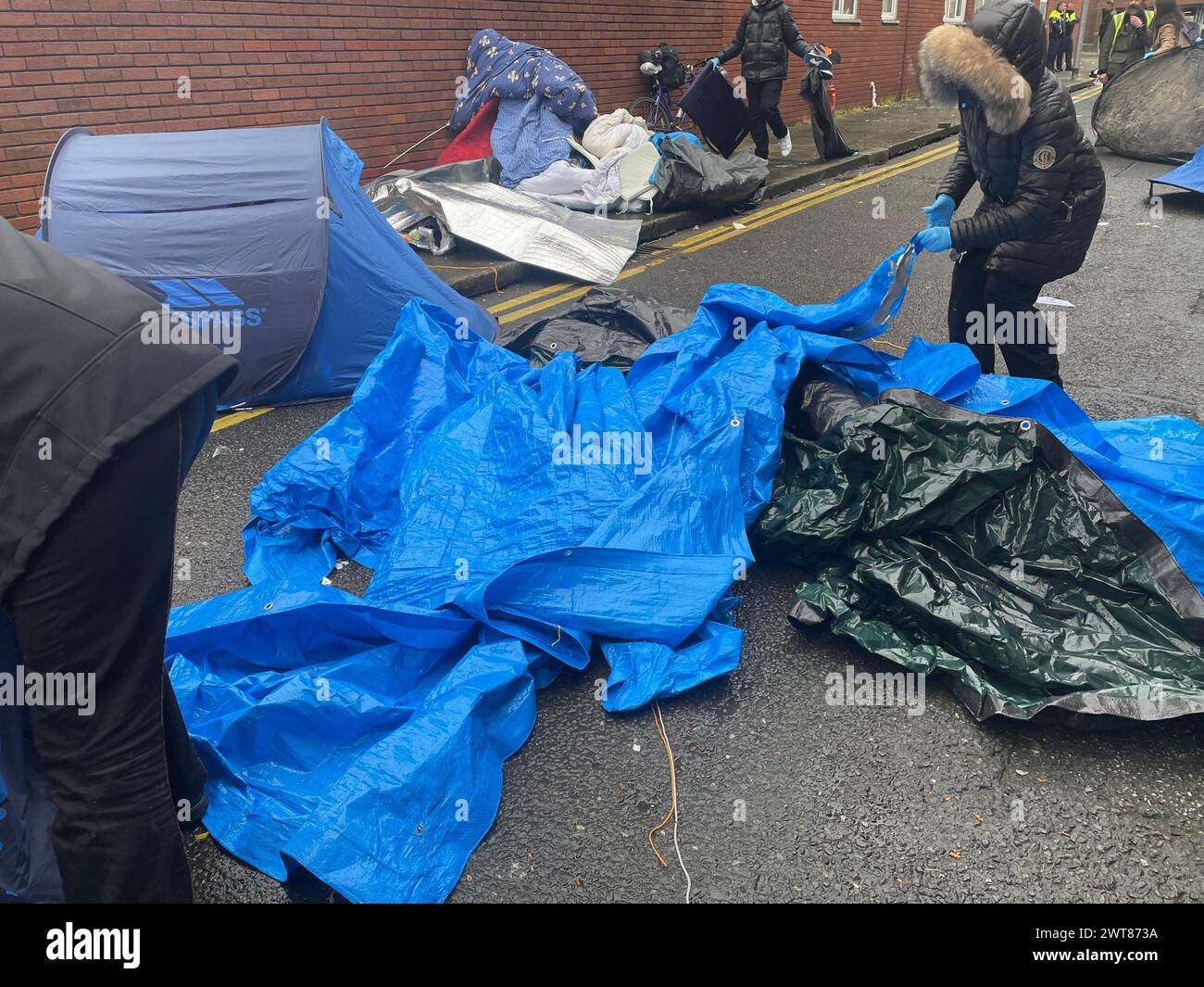 Tents are cleared after men who had been camping at the International ...