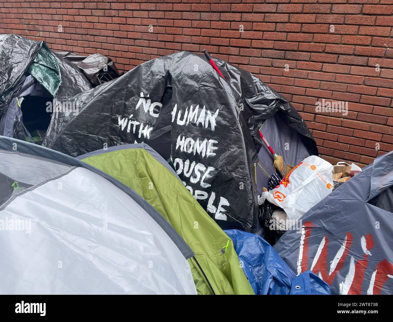 Tents are cleared after men who had been camping at the International ...