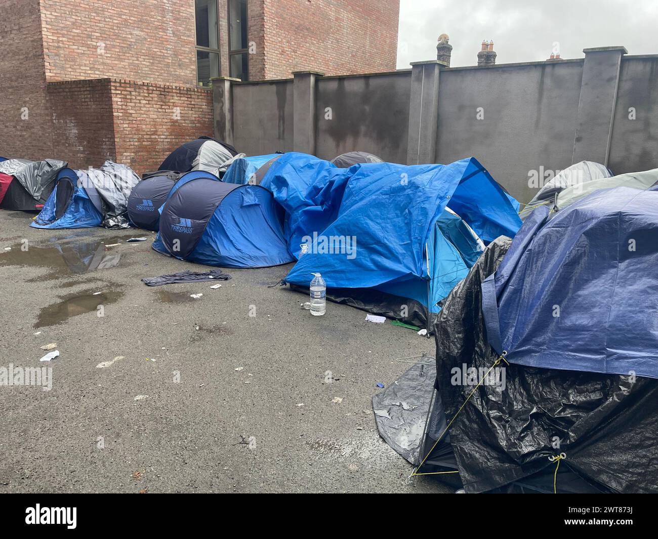 Tents are cleared after men who had been camping at the International ...