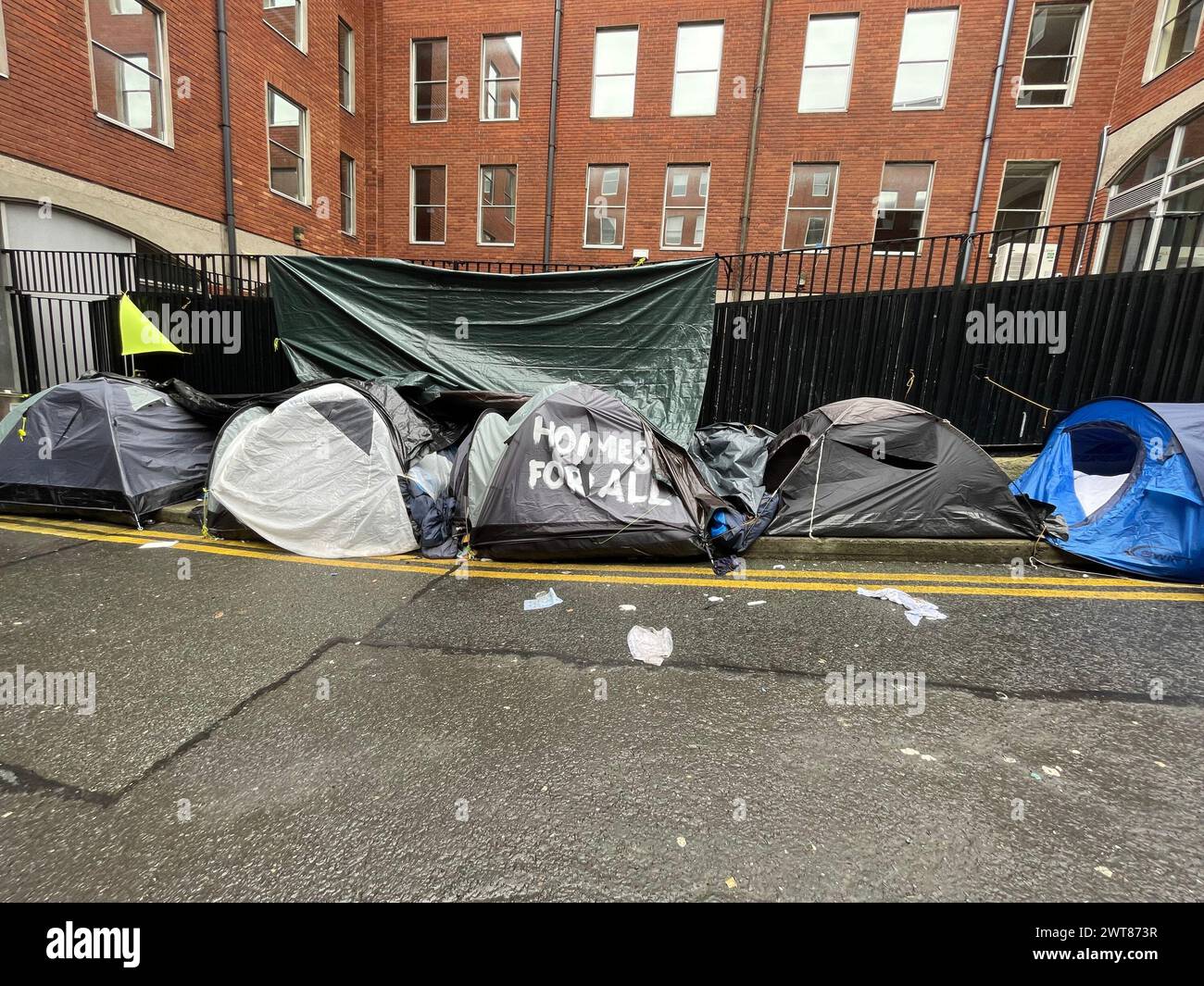 Tents are cleared after men who had been camping at the International ...