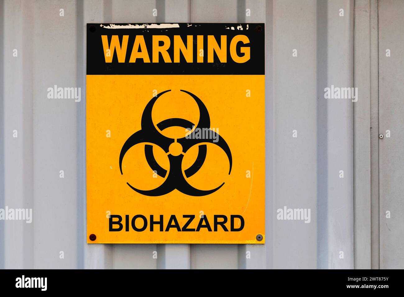 Warning sign drawn on a black and yellow placard with written in ...