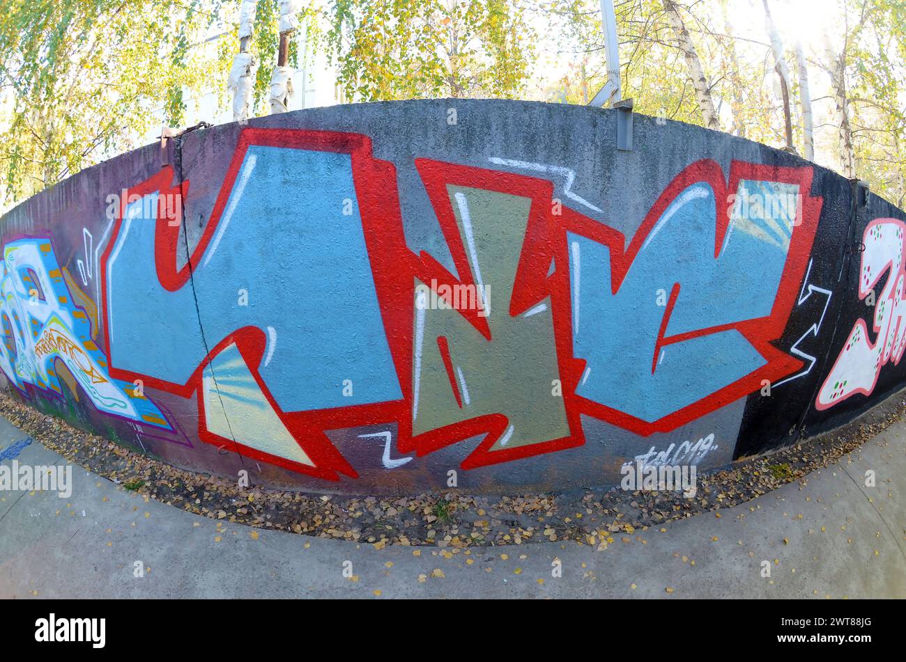 Fisheye shot of street art graffiti drawing on wall. Spray art artwork ...