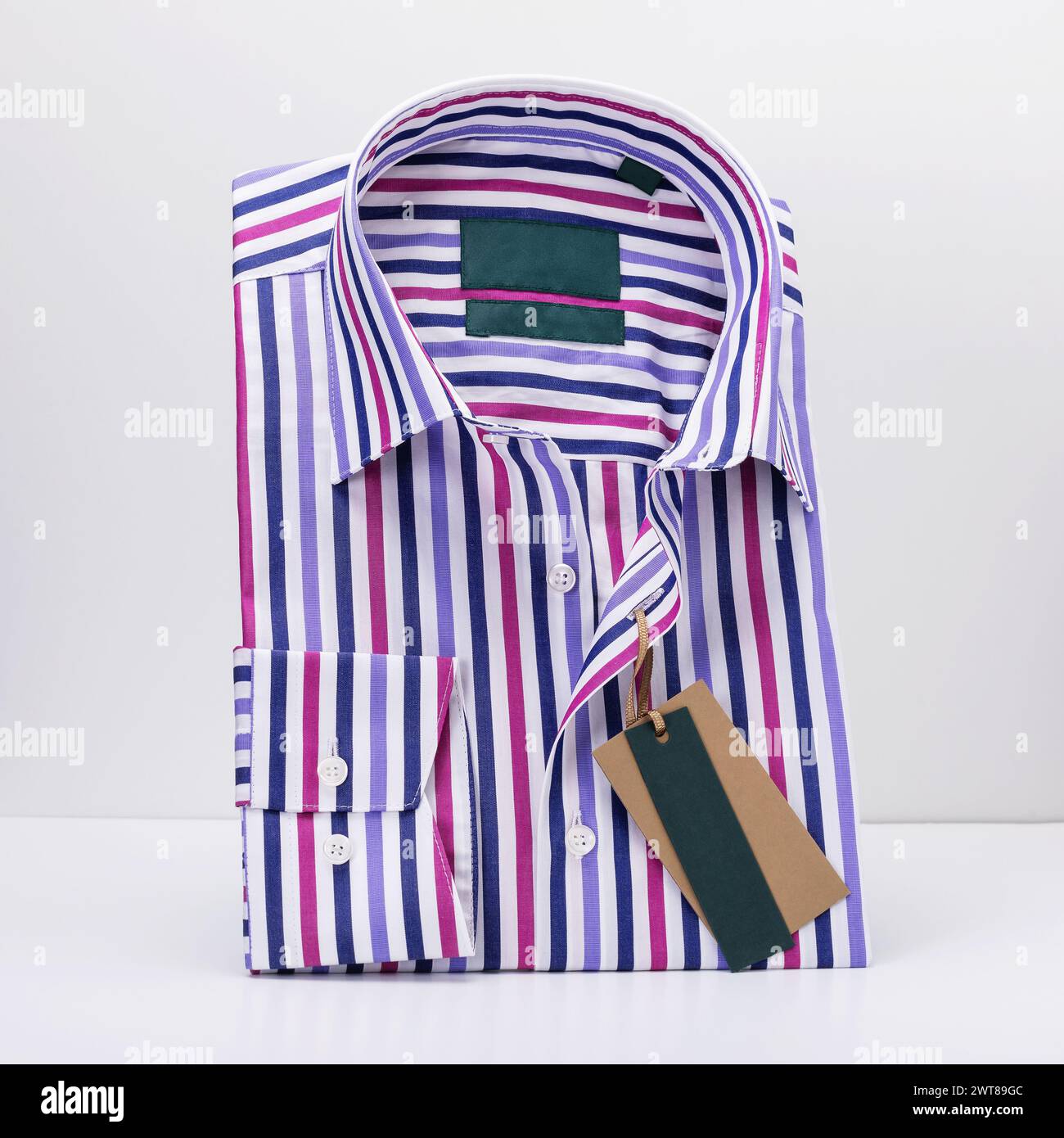 Classic folded men's shirt in colored stripes with long sleeves on a ...