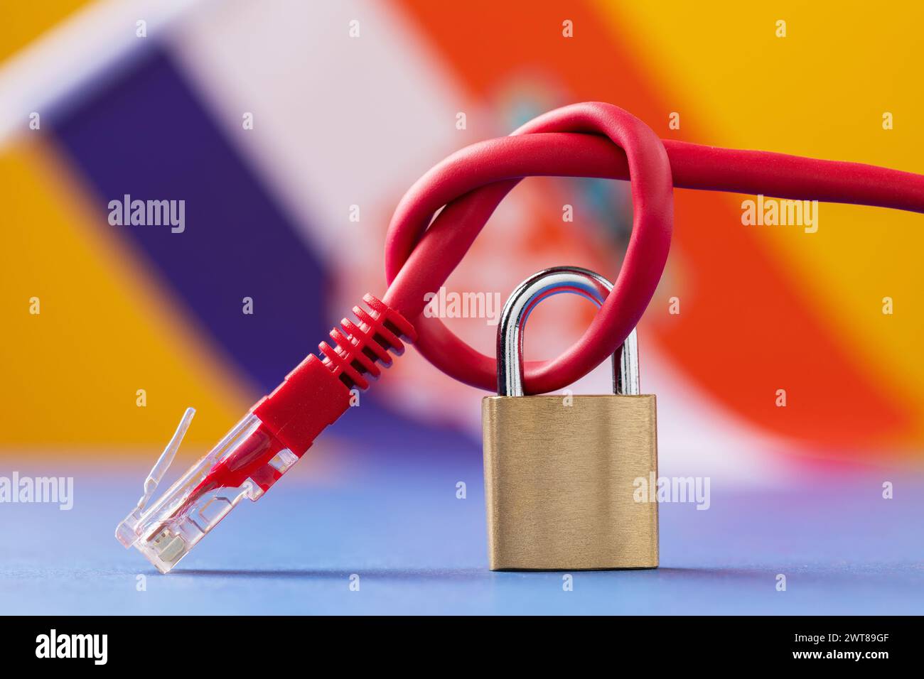 A closed lock on a tied network wire into a knot against the background ...